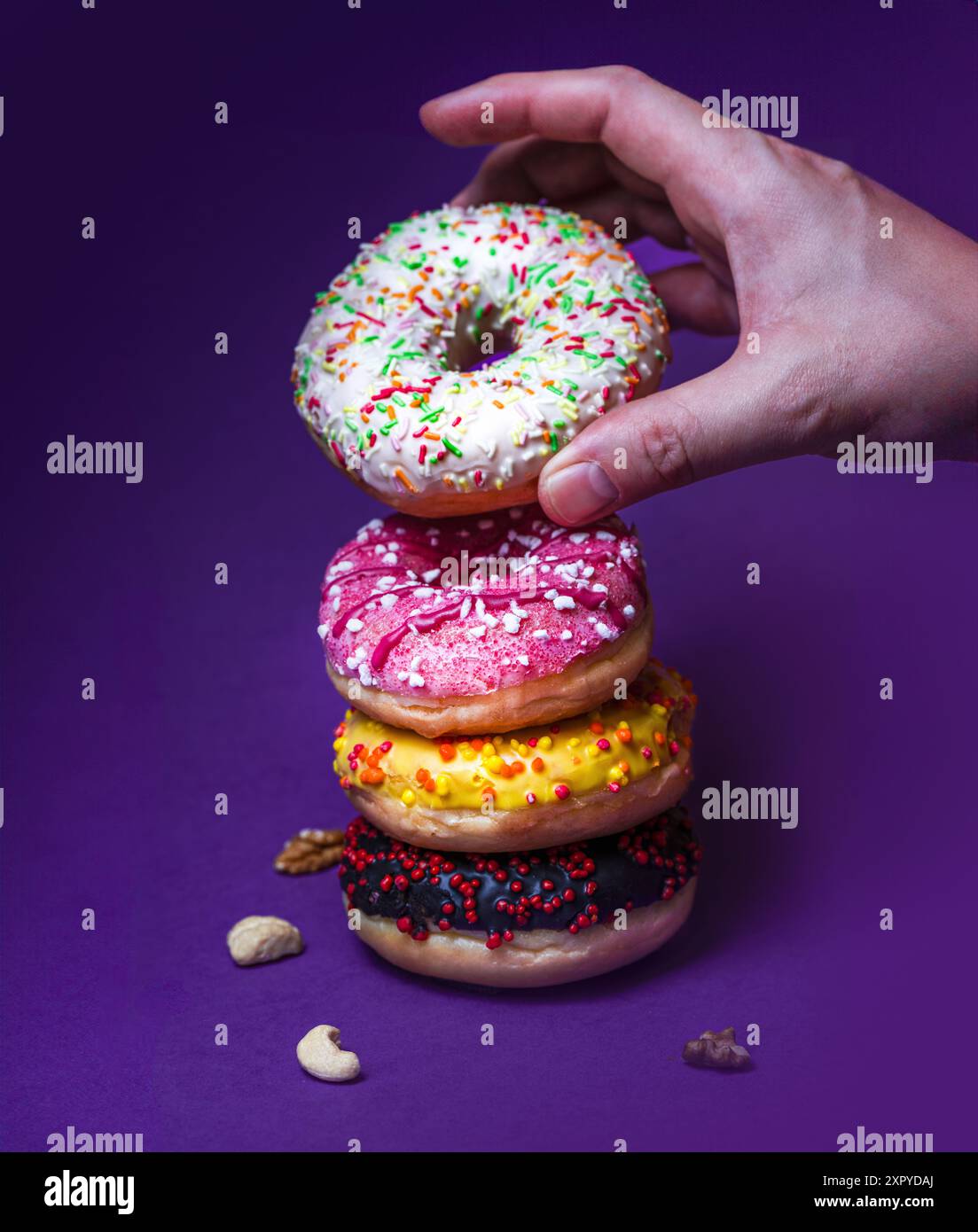 Hand holding donut. Colorful sprinkles. Pastel background Stock Photo ...
