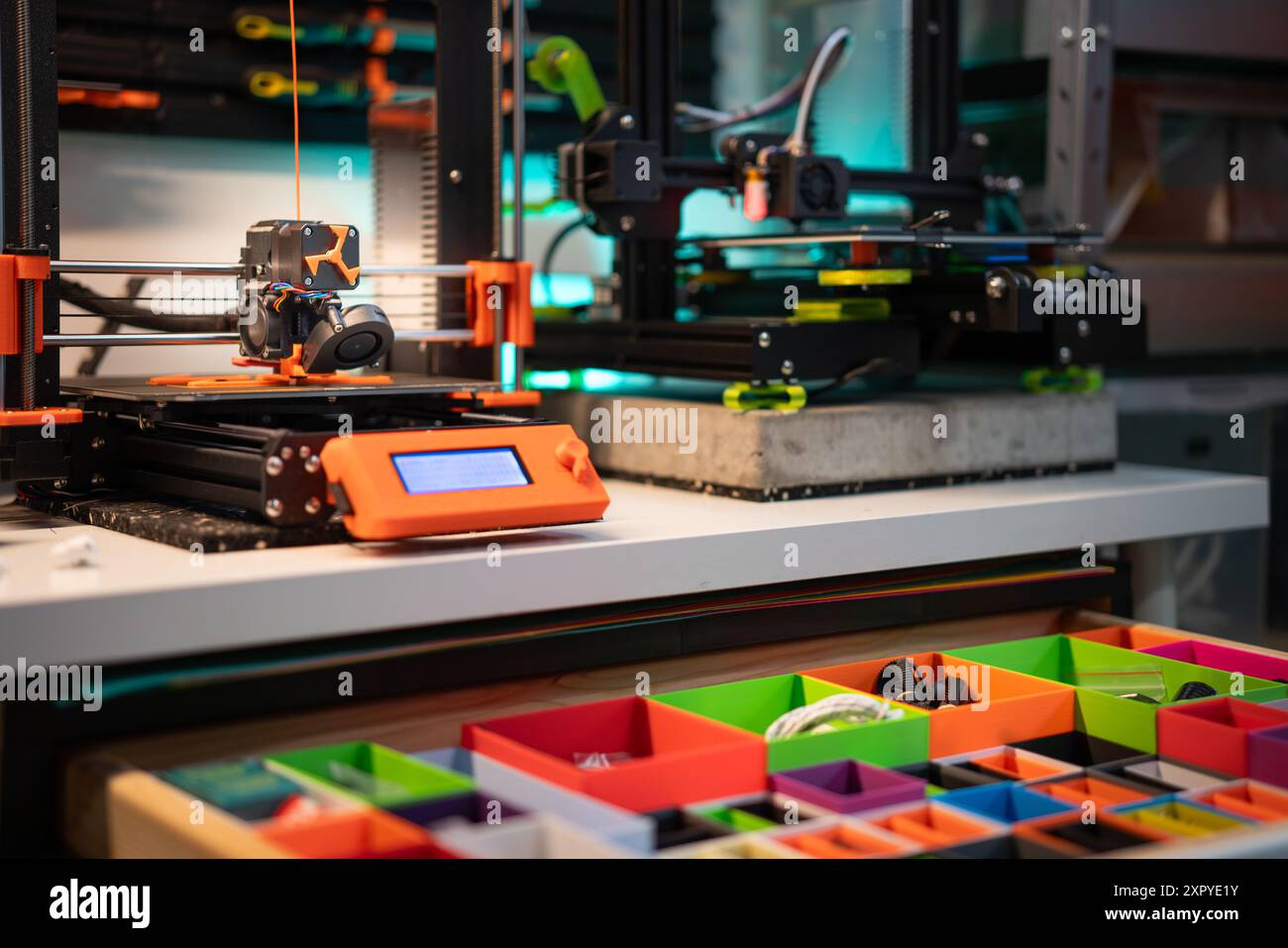 Home studio. 3D printers at work. Production, passion and hobby. Orange ...
