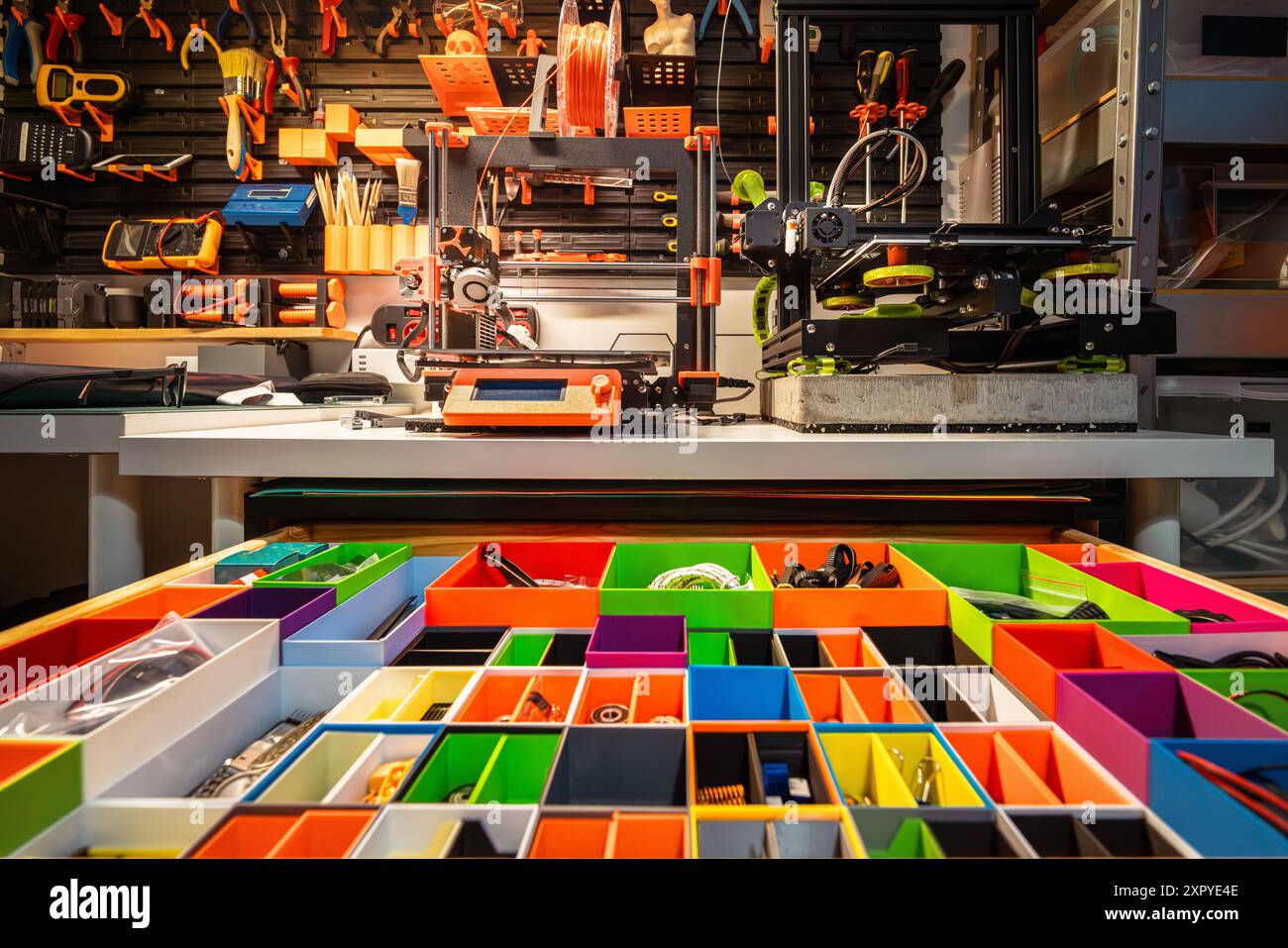 Drawer with colorful compartments for parts. Home workshop. Wall with ...