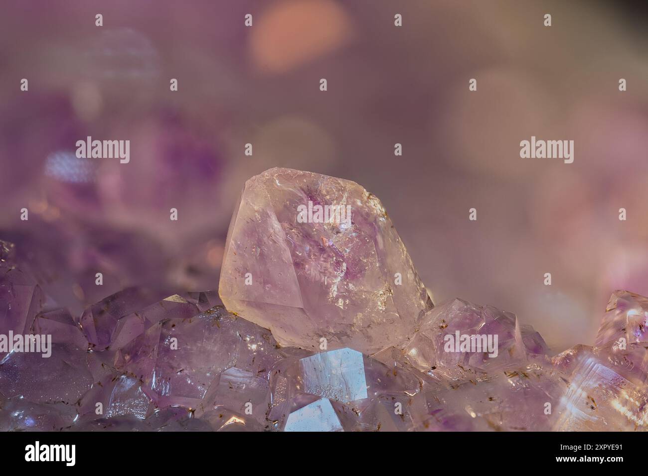 Close up pink shiny amethyst with inclusions, quartz crystal texture ...