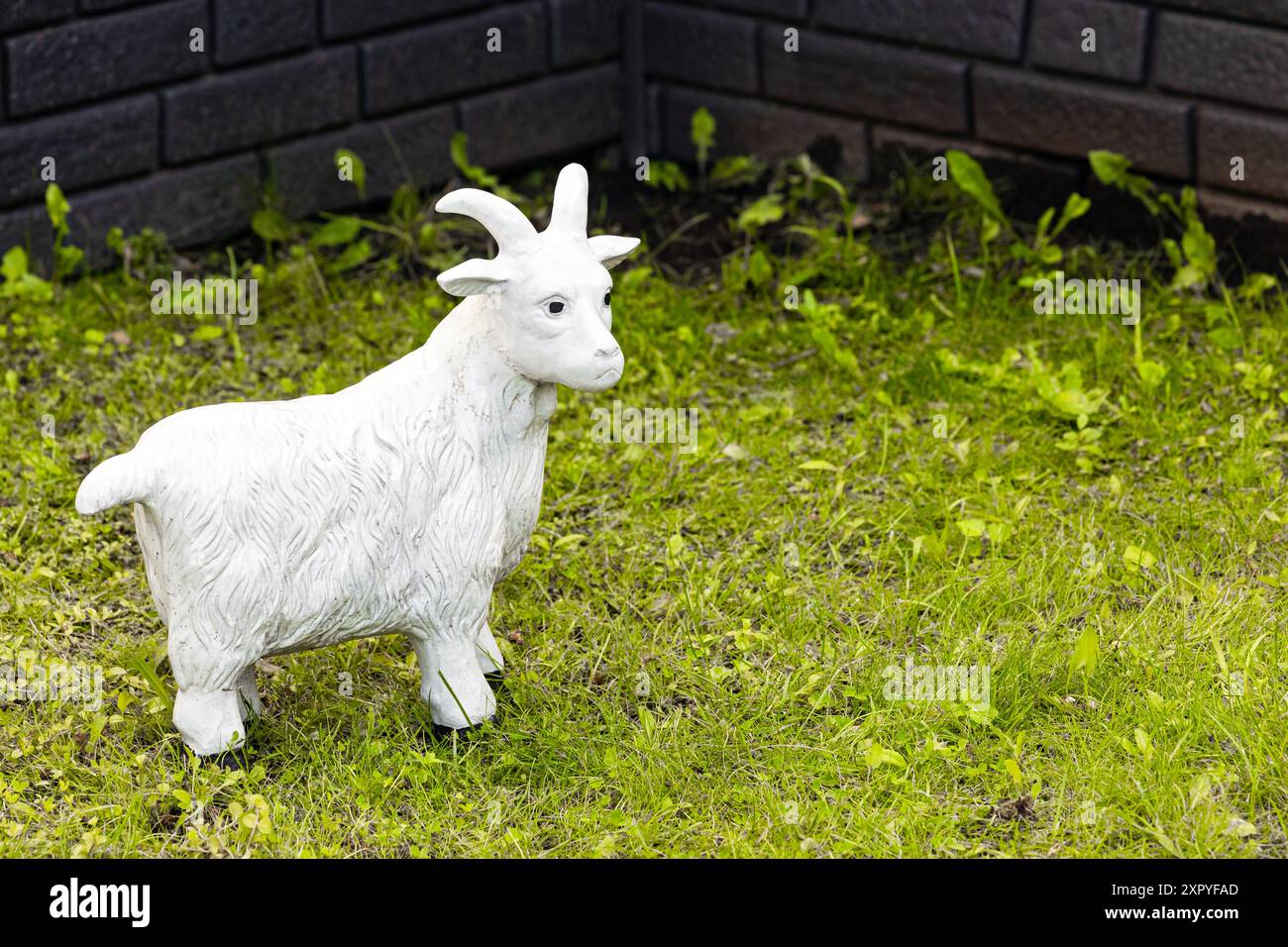 decorative figure of a goat in the courtyard of a house Stock Photo - Alamy