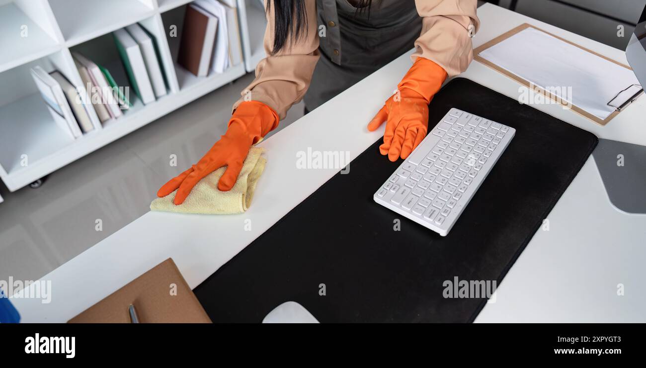 Professional Maid Housekeeper Cleaning Office Desk with Orange Gloves ...