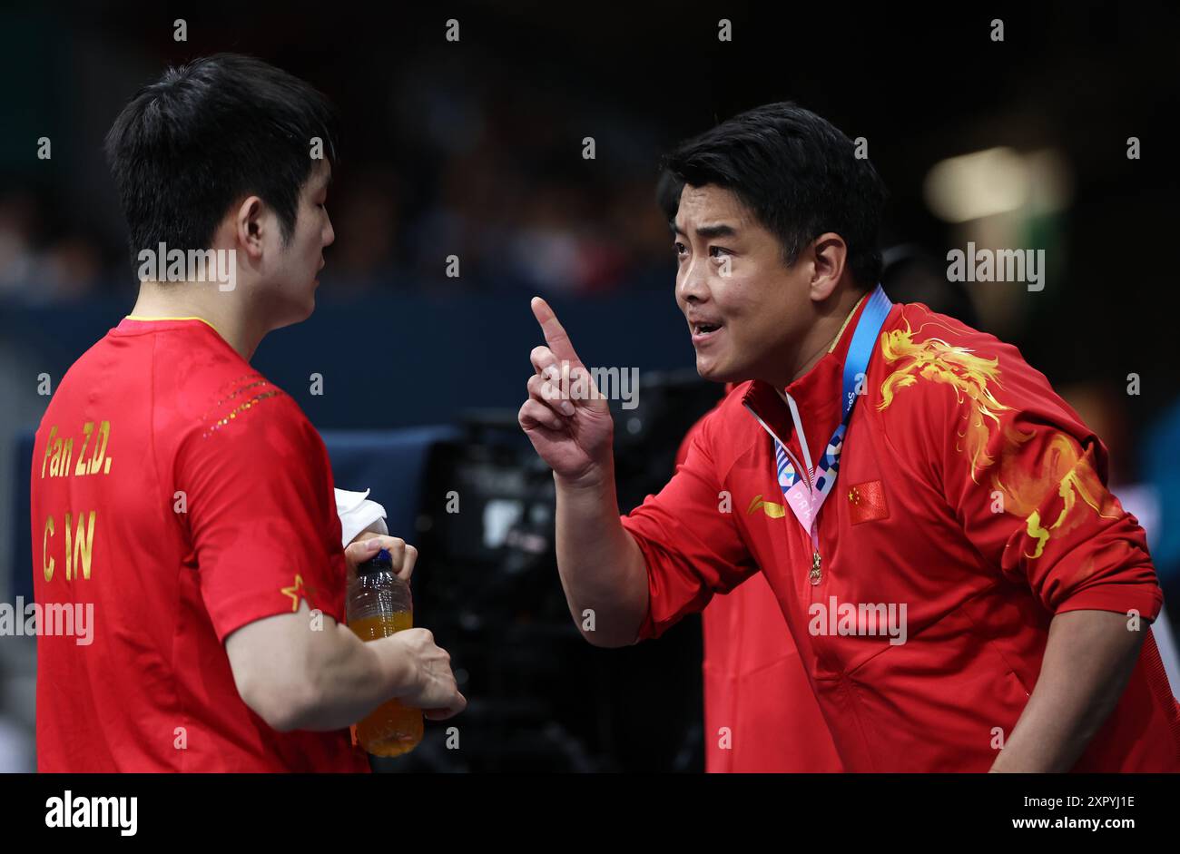 Paris, France. 8th Aug, 2024. Coach Wang Hao (R) of China instructs Fan Zhendong of China during ...