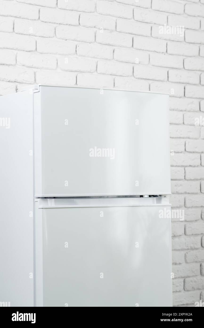 White Refrigerator In A Modern Kitchen With Brick Wall Stock Photo - Alamy