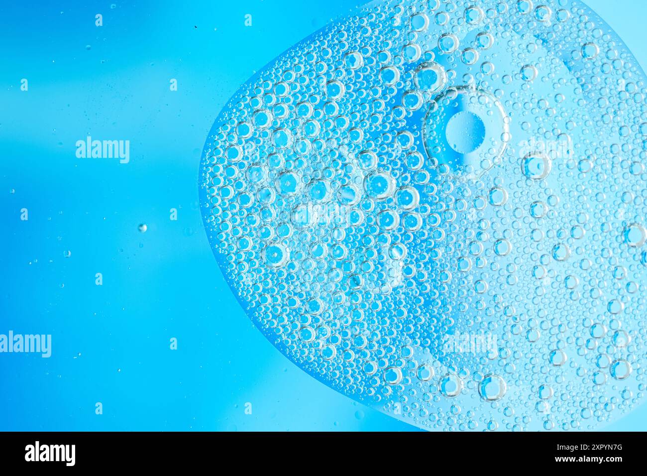 Abstract image featuring a blue, organic-shaped liquid form with ...