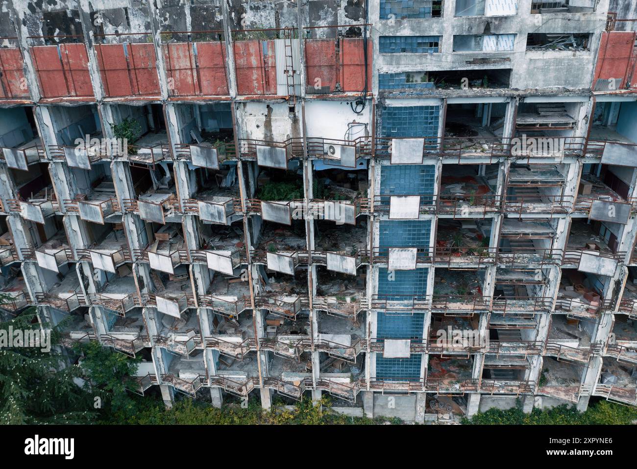Aerial view of abandoned building complex, with overgrown vegetation ...