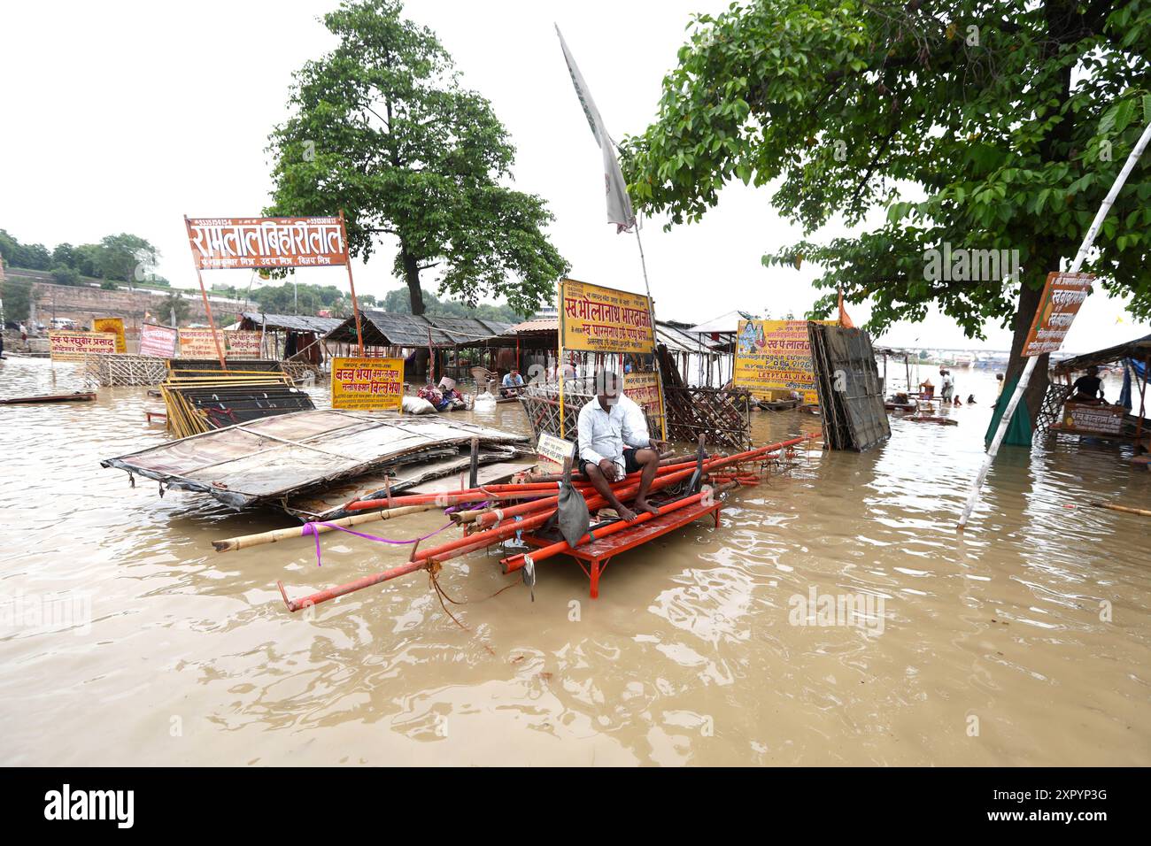 A man sit at submerged place at the bank of Sangam as water level of ...
