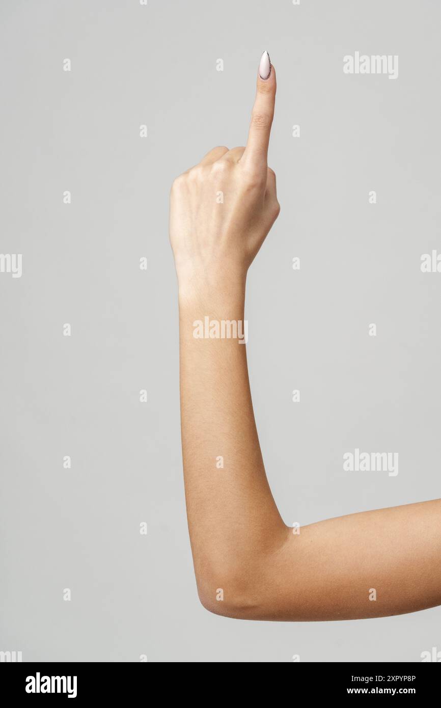 Woman's Hand Pointing Upward With Elbows Bent Stock Photo - Alamy