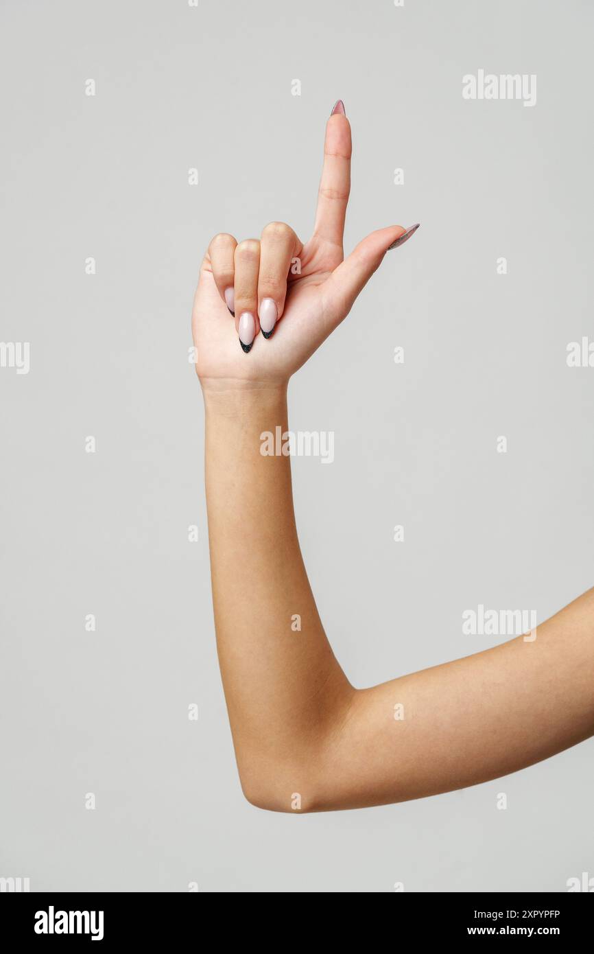 Woman's Hand Pointing Upward With Elbows Bent Stock Photo - Alamy