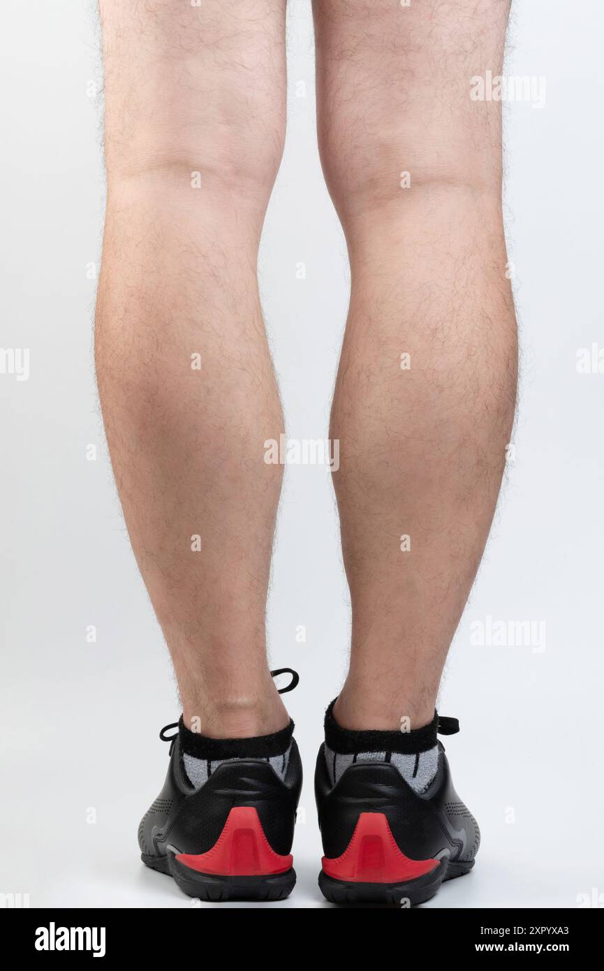 Man legs in black sport shoes back rear view isolated on studio ...