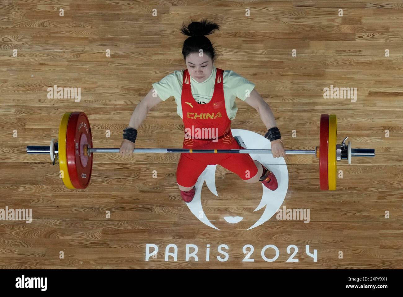 Luo Shifang of China competes during the women's 59kg weightlifting ...