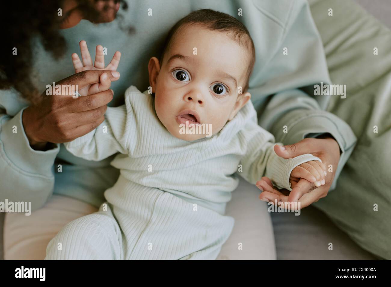 Male infant making surprising face while his mother holding him Stock ...