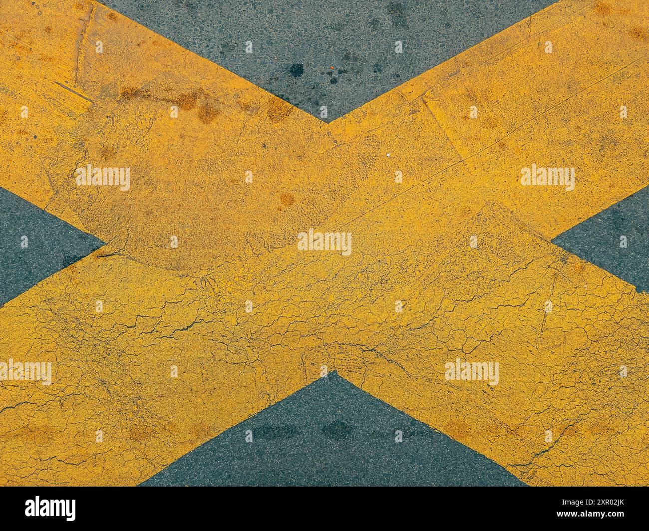 Yellow cross X marking on dark asphalt road surface, top view Stock ...