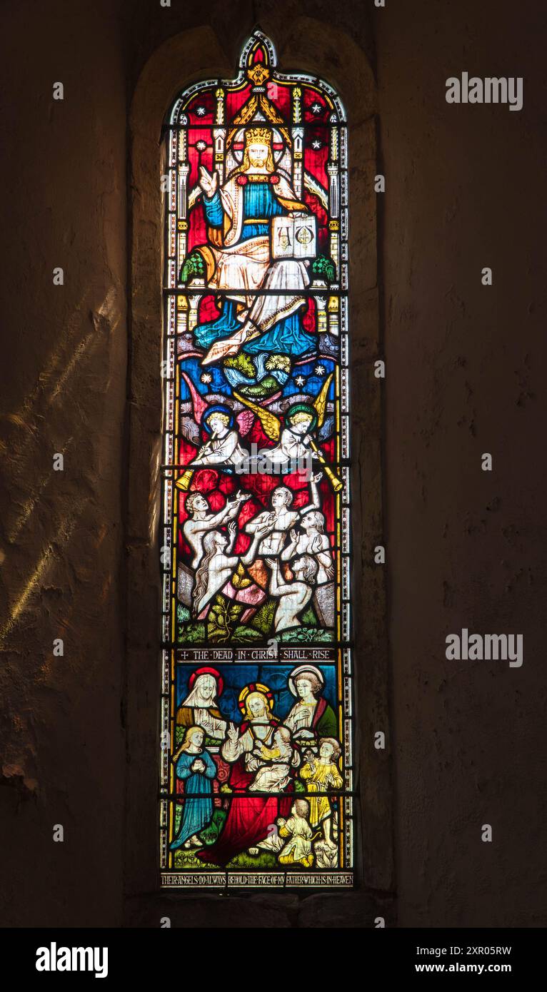 Stained glass depicting Christ holding a book with the symbols Alpha ...