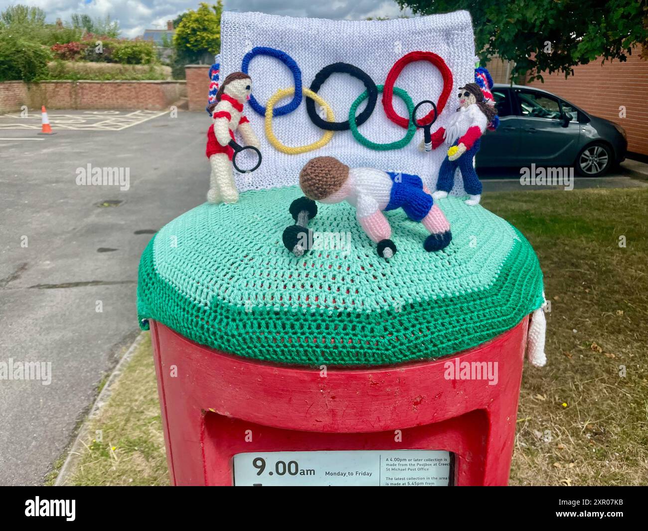 knitted olympic figures mounted on a post box in rushton somerset ...