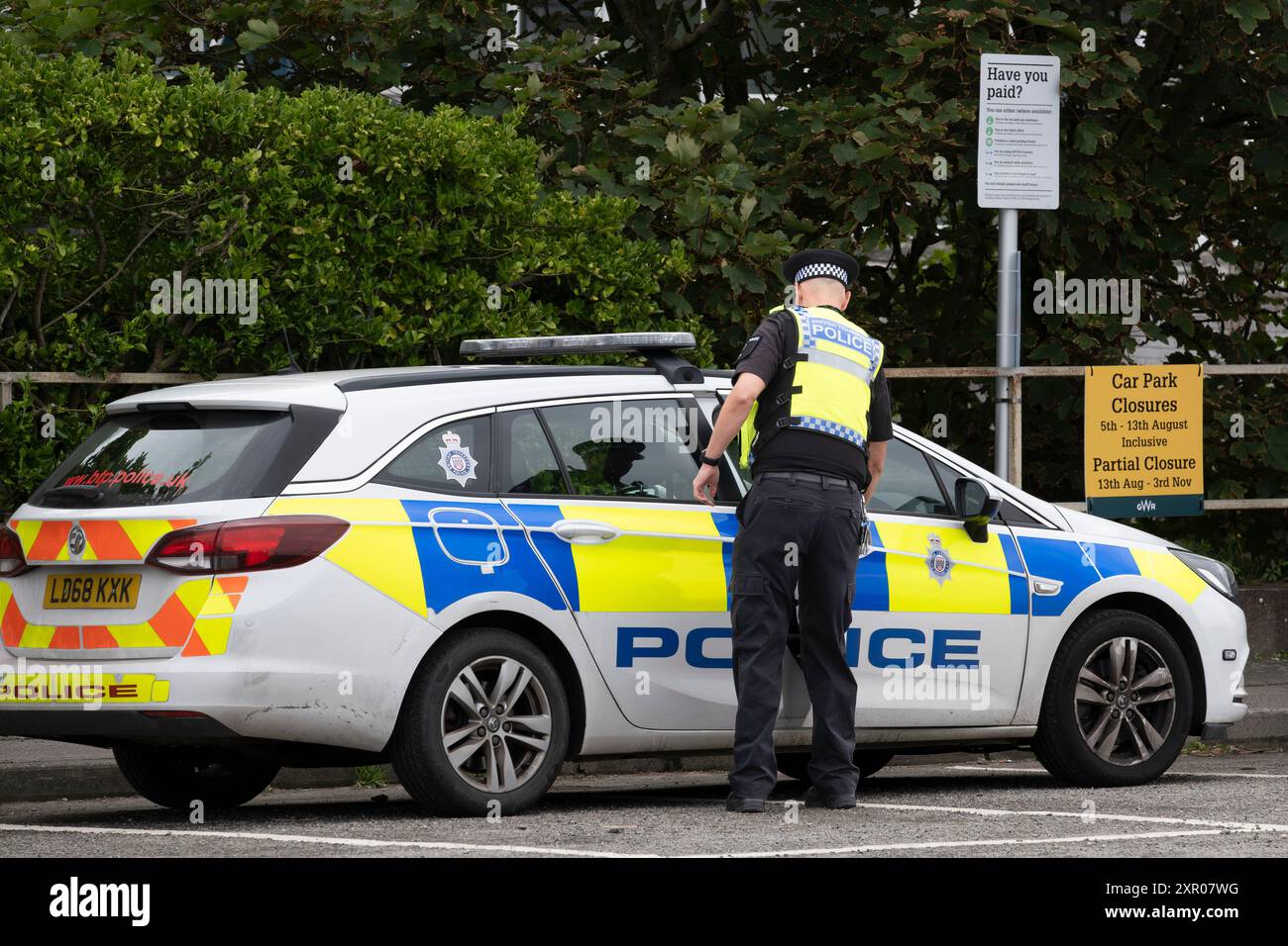 A British Transport Police Officer opening his patrol car door in ...