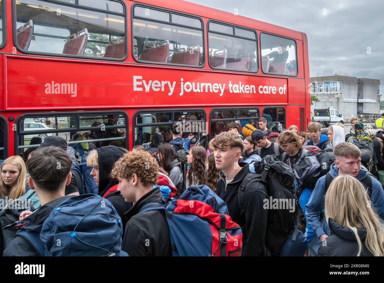 Young people queuing to board buses to take them to the Boardmasters ...