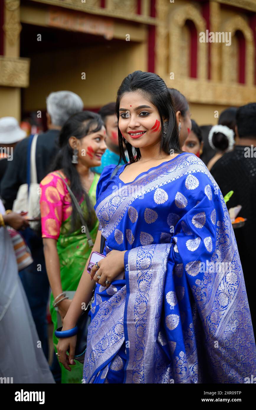 Portrait of beautiful young woman wearing a traditional Bengali festive ...