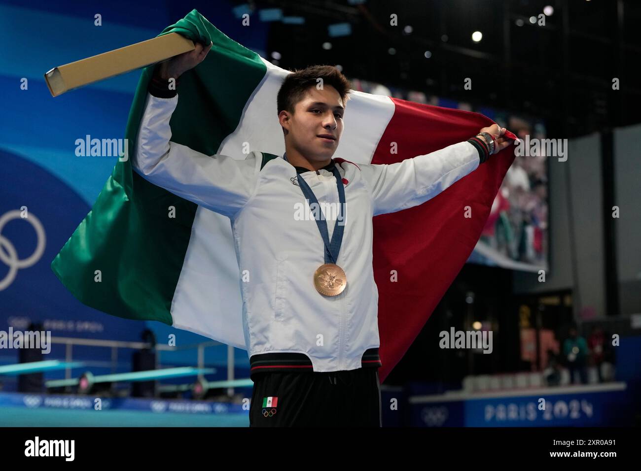 Bronze medalist Mexico's Osmar Olvera Ibarra holds his national flag ...