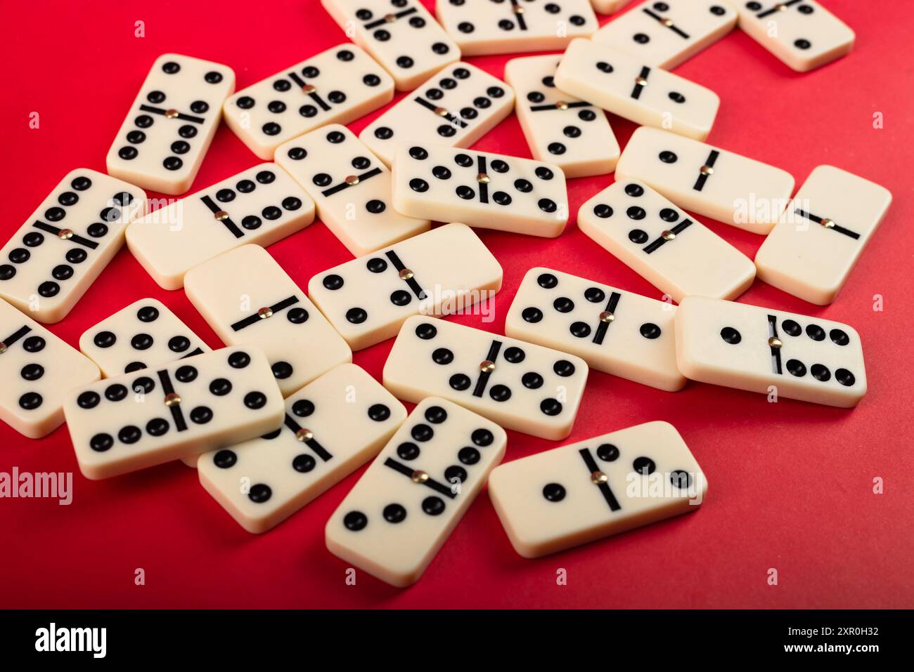 Dominoes on a red background. White Bones Board Game Stock Photo - Alamy