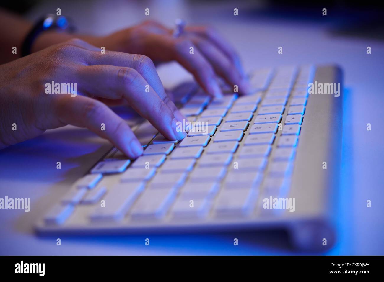 Typing on Modern Keyboard in Low Light Setting Stock Photo - Alamy