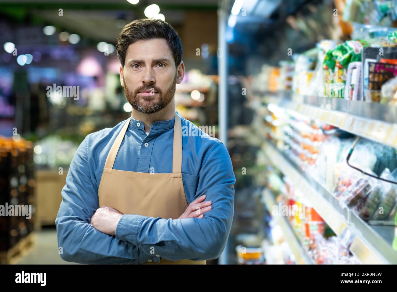 Serious supermarket manager arms crossed hi-res stock photography and ...
