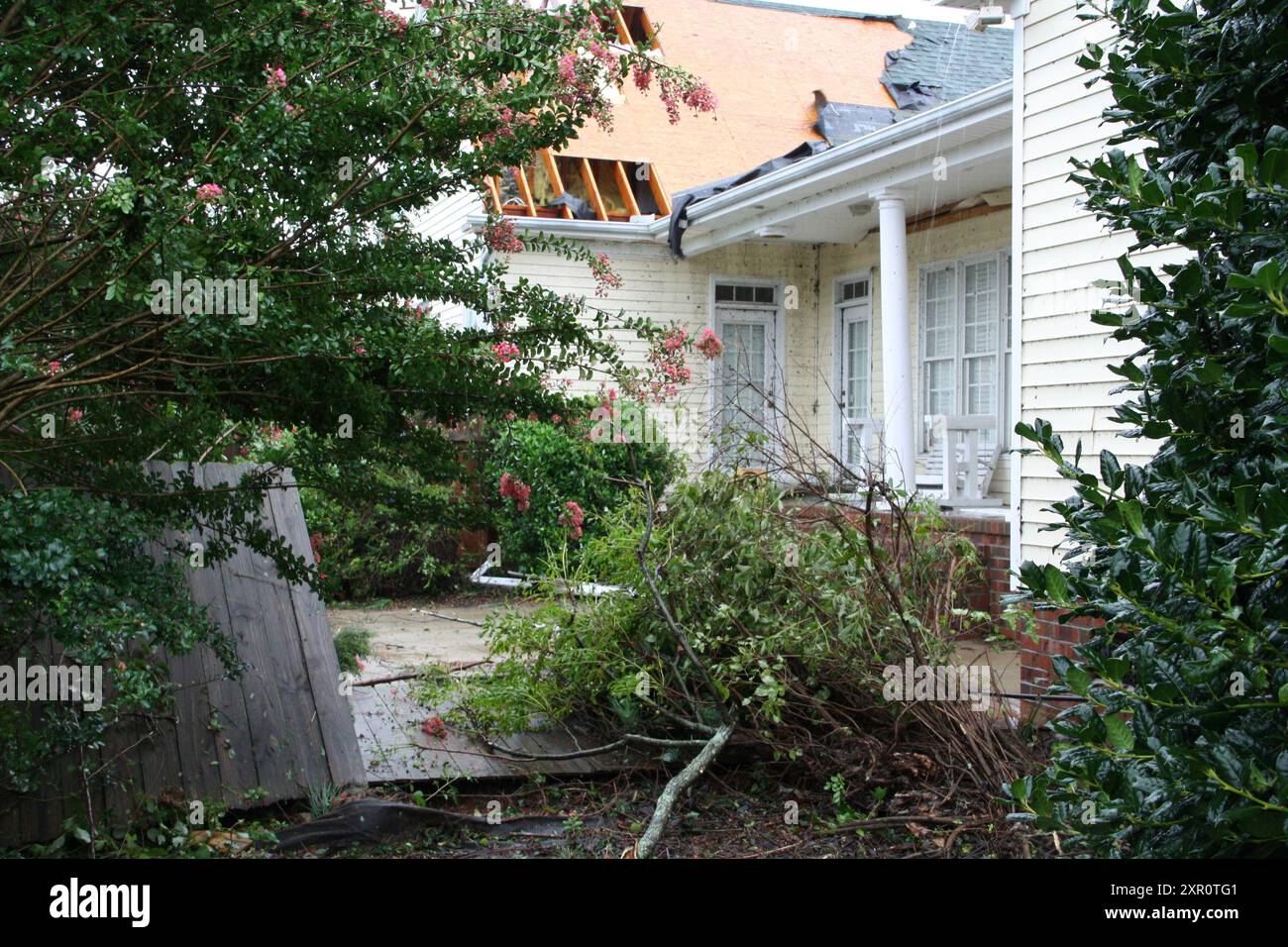 Parts of the roofing of Genesis Cooper's home flaps in the wind after a ...