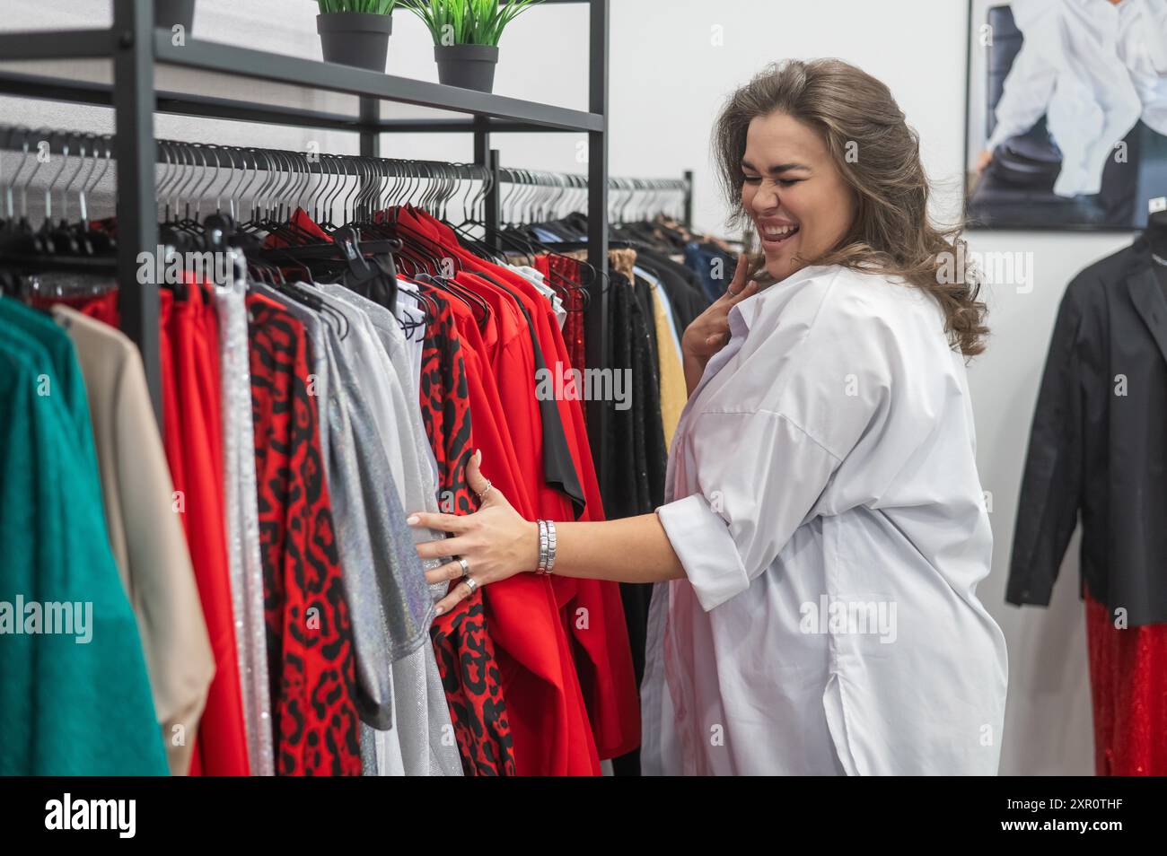 A fat woman chooses clothes in a plus size store Stock Photo - Alamy