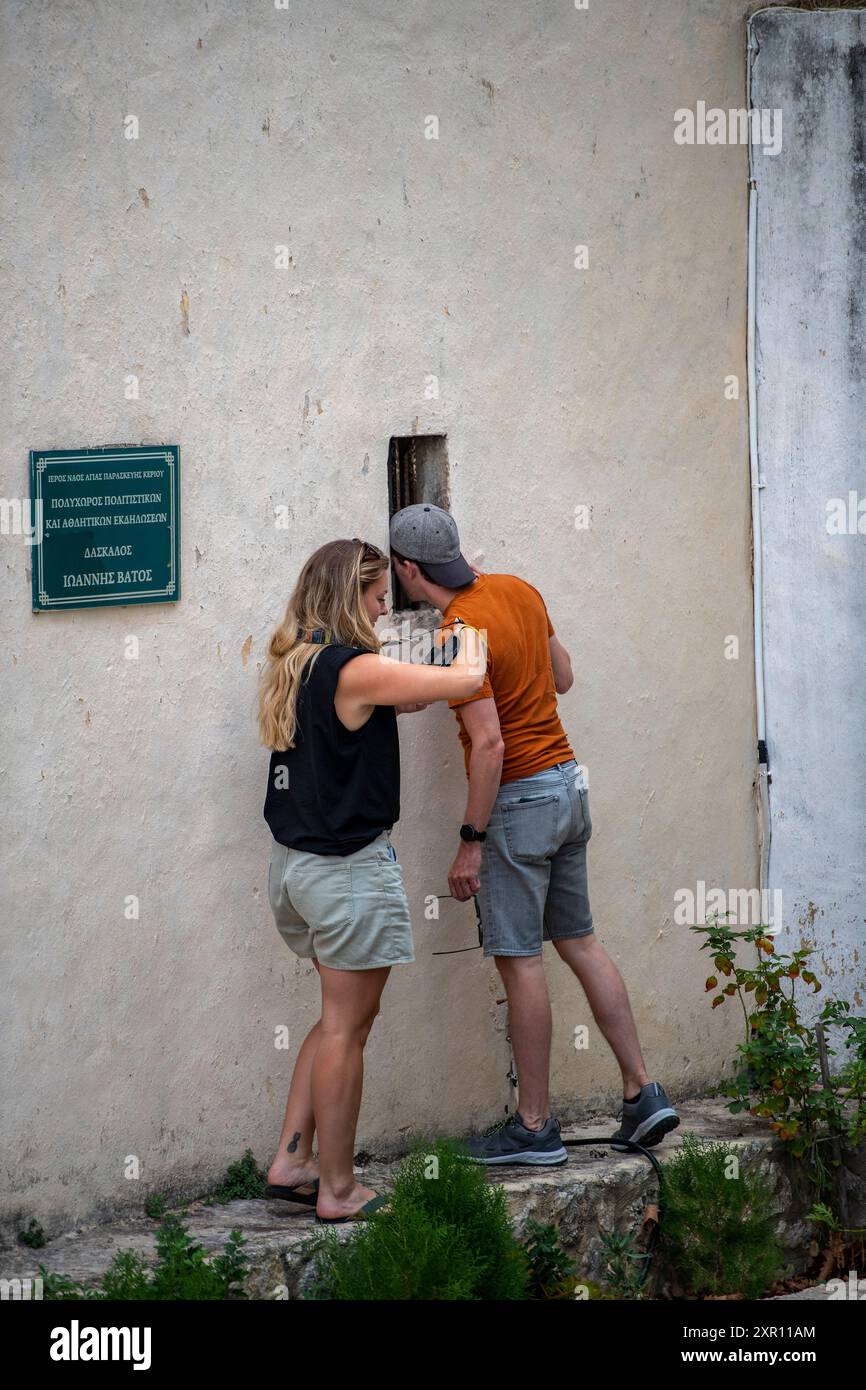young couple exploring derelict building in greece, young man and woman ...