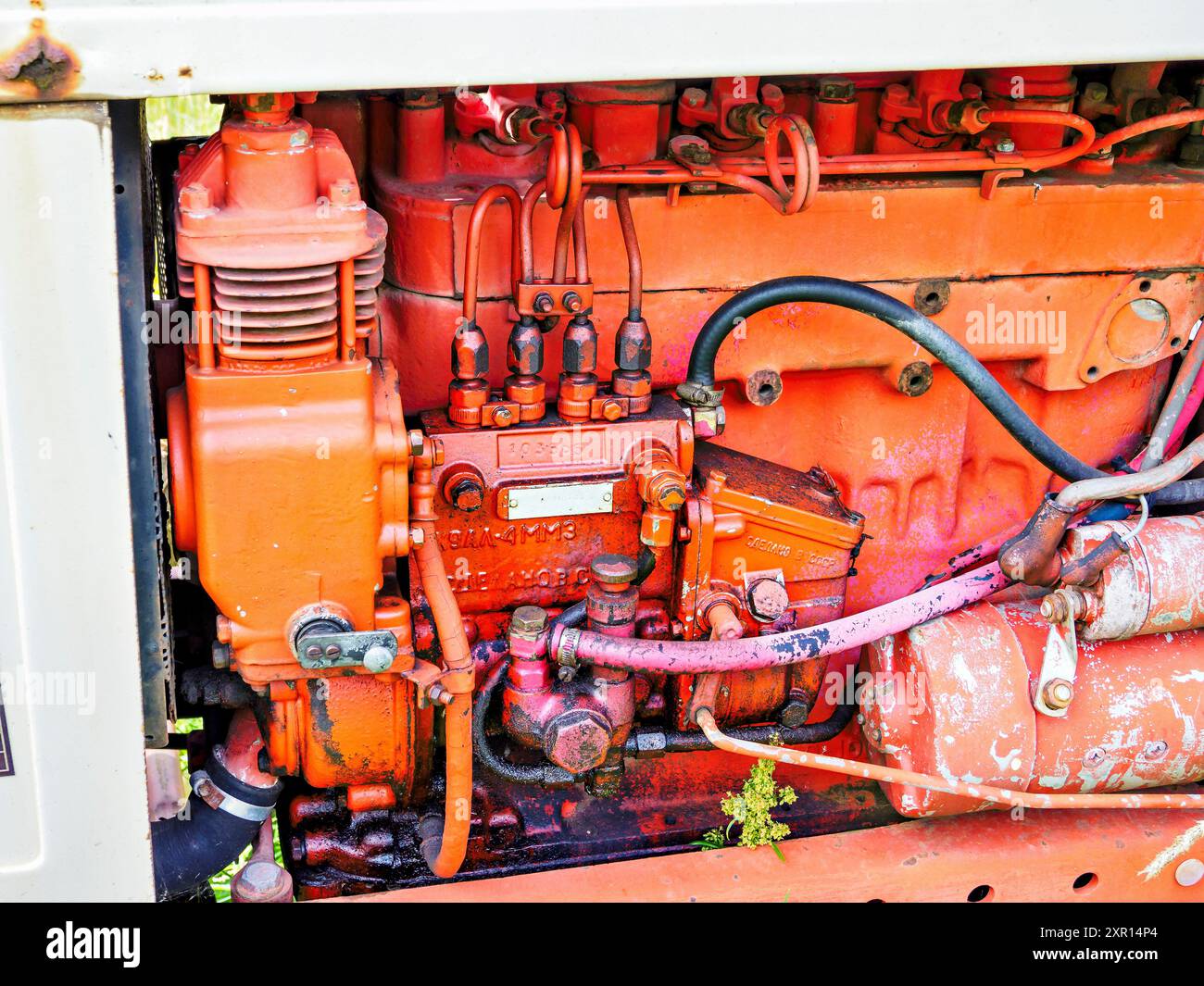 Close-up view of an old, worn-out, orange mechanical engine with ...