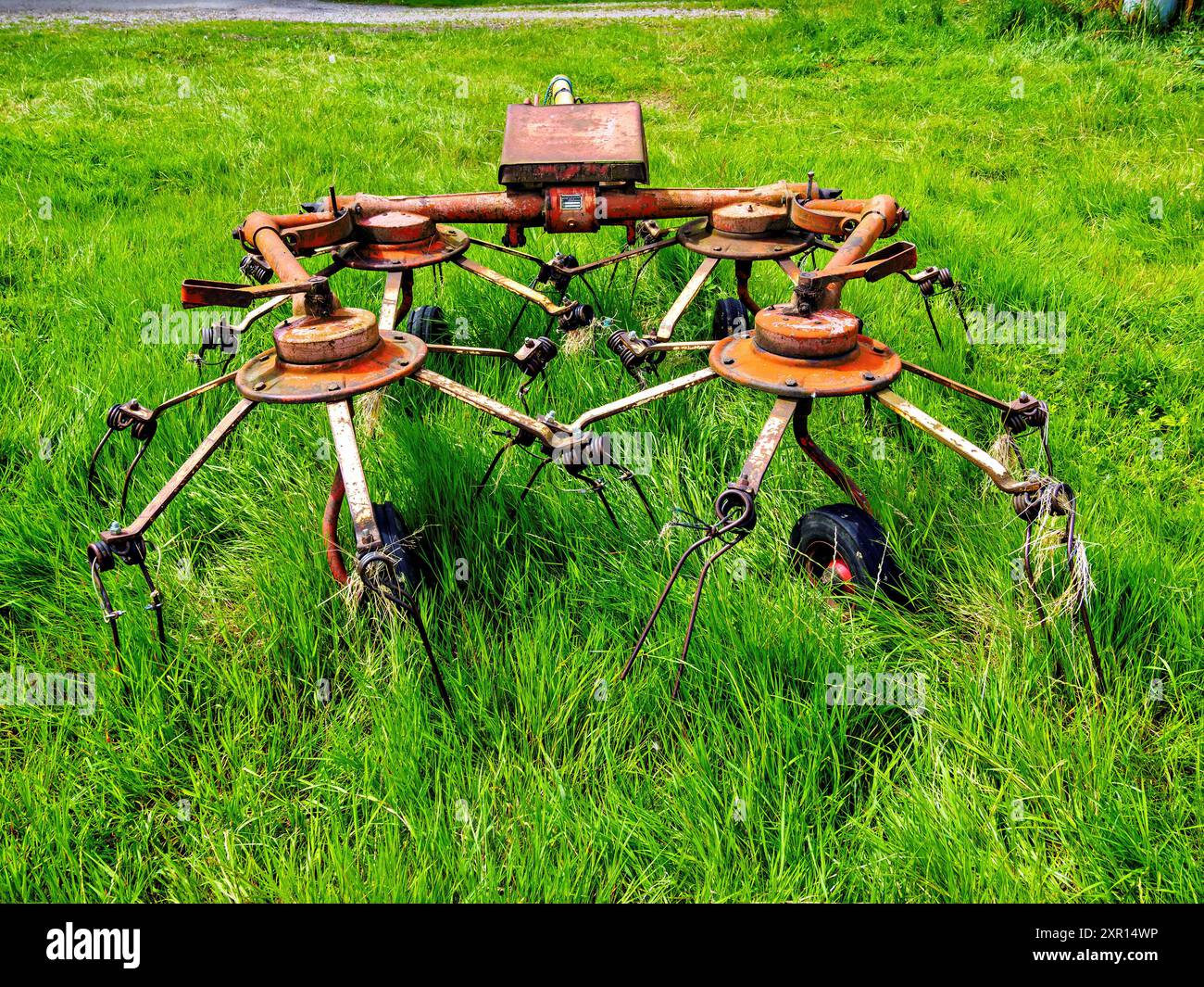 Rustic agricultural machinery on a lush green field, showcasing vintage ...