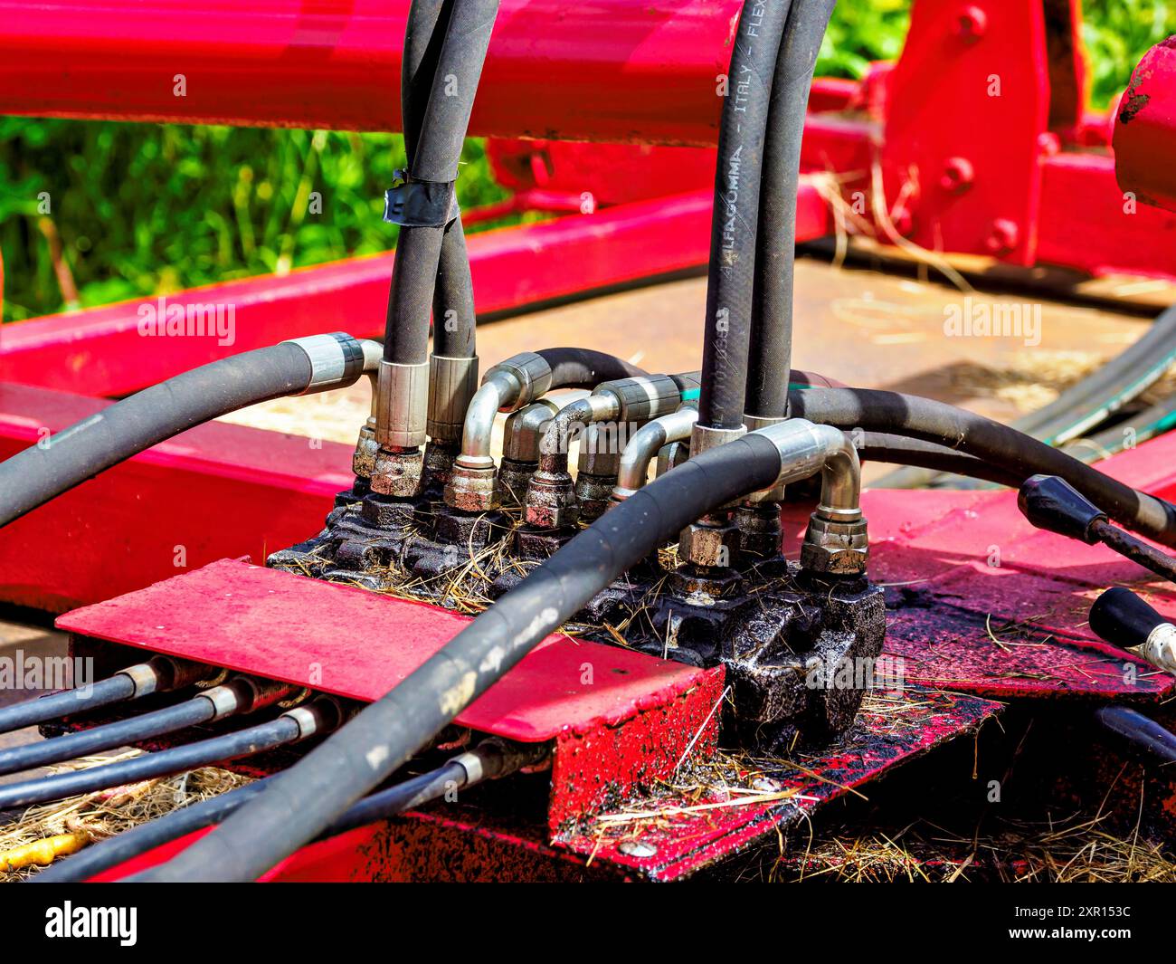 Close-up of hydraulic hoses and fittings on farm machinery, displaying ...