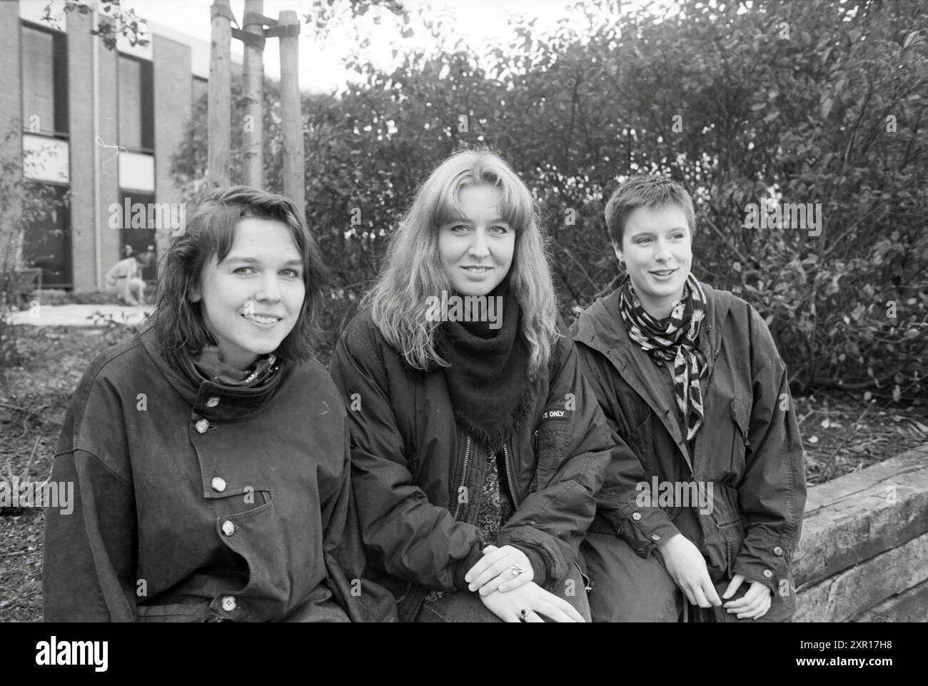 Three Swedish girls at H.D., posing in front of a company building ...