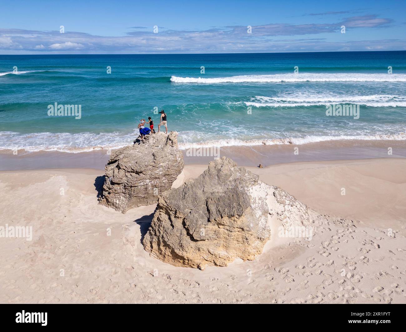 Family look at the ocean from a rock at Salmon Beach, near Windy ...