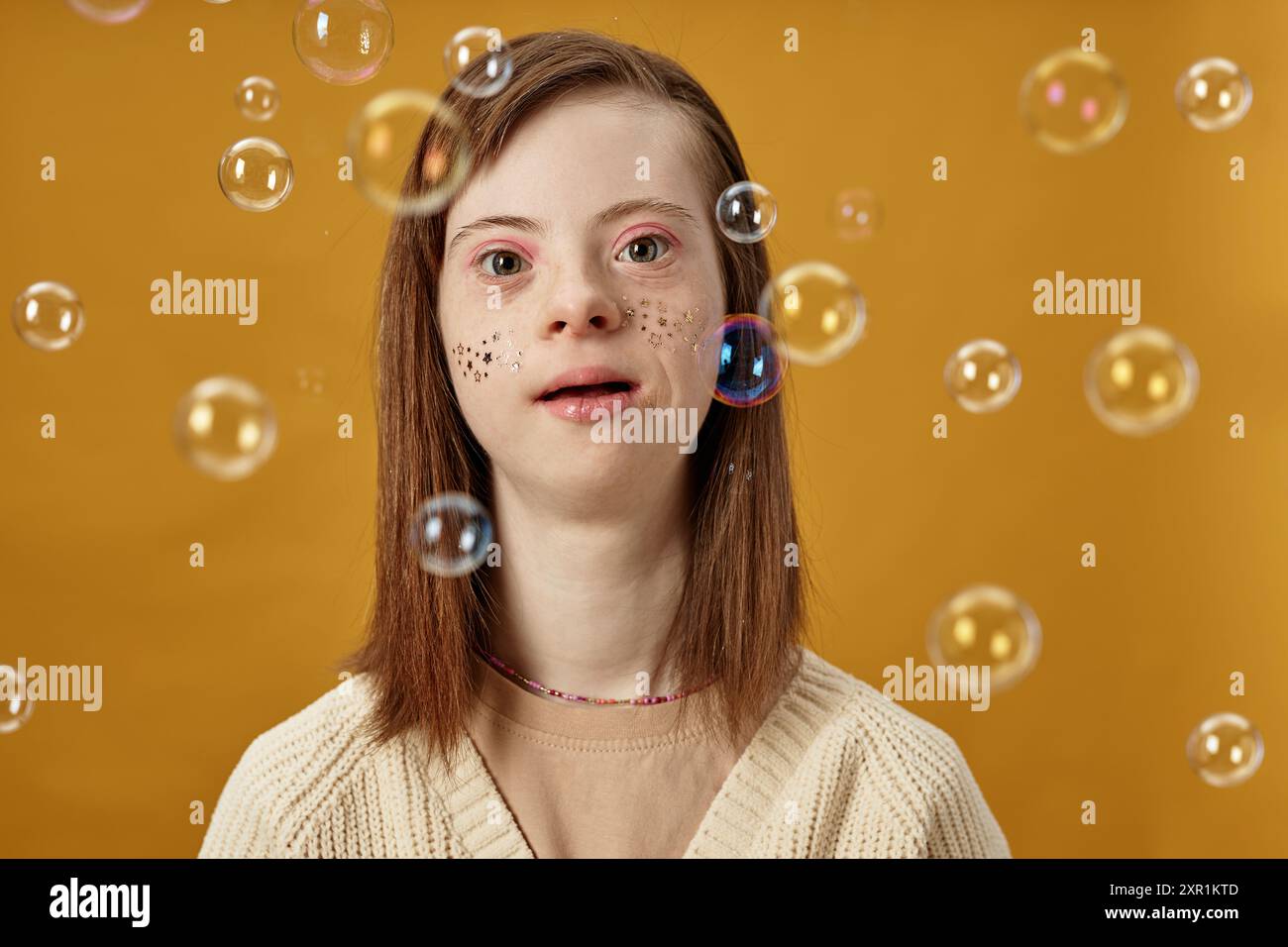 Portrait of young girl with freckles and Down syndrome captured with ...