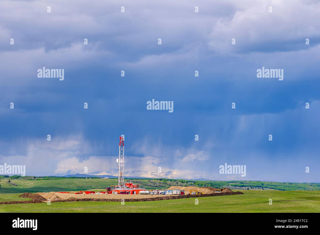 A drilling rig on a well site in the foothills of the Rocky Mountains ...