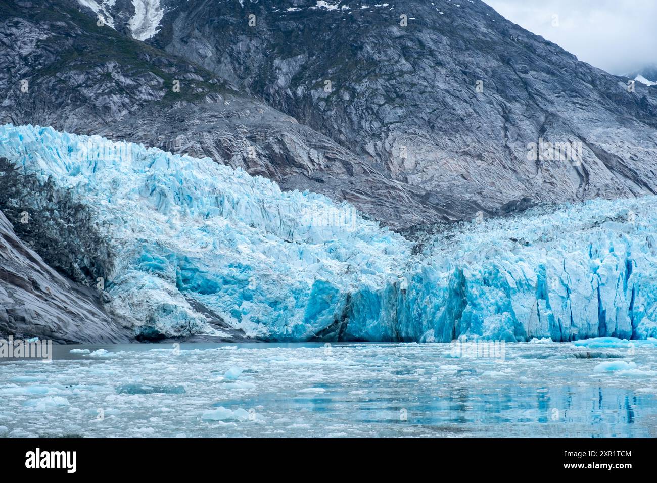 Glacial terminus with dirt and clouds and floating ice Stock Photo - Alamy