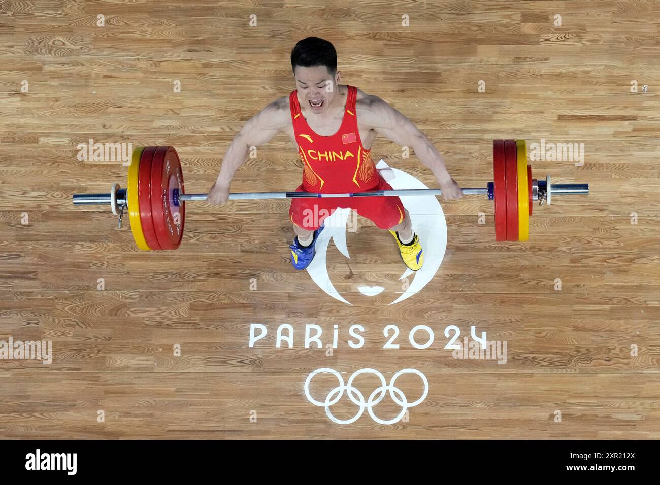 Shi Zhiyong of China competes during the men's 73kg weightlifting event ...