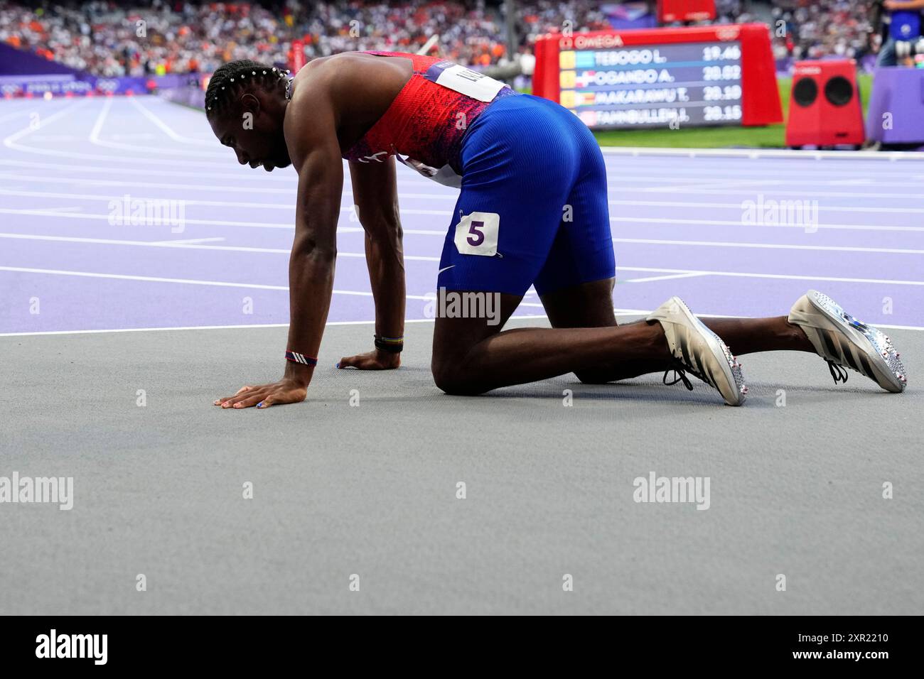 Noah Lyles, of the United States, rests on the track following the men ...