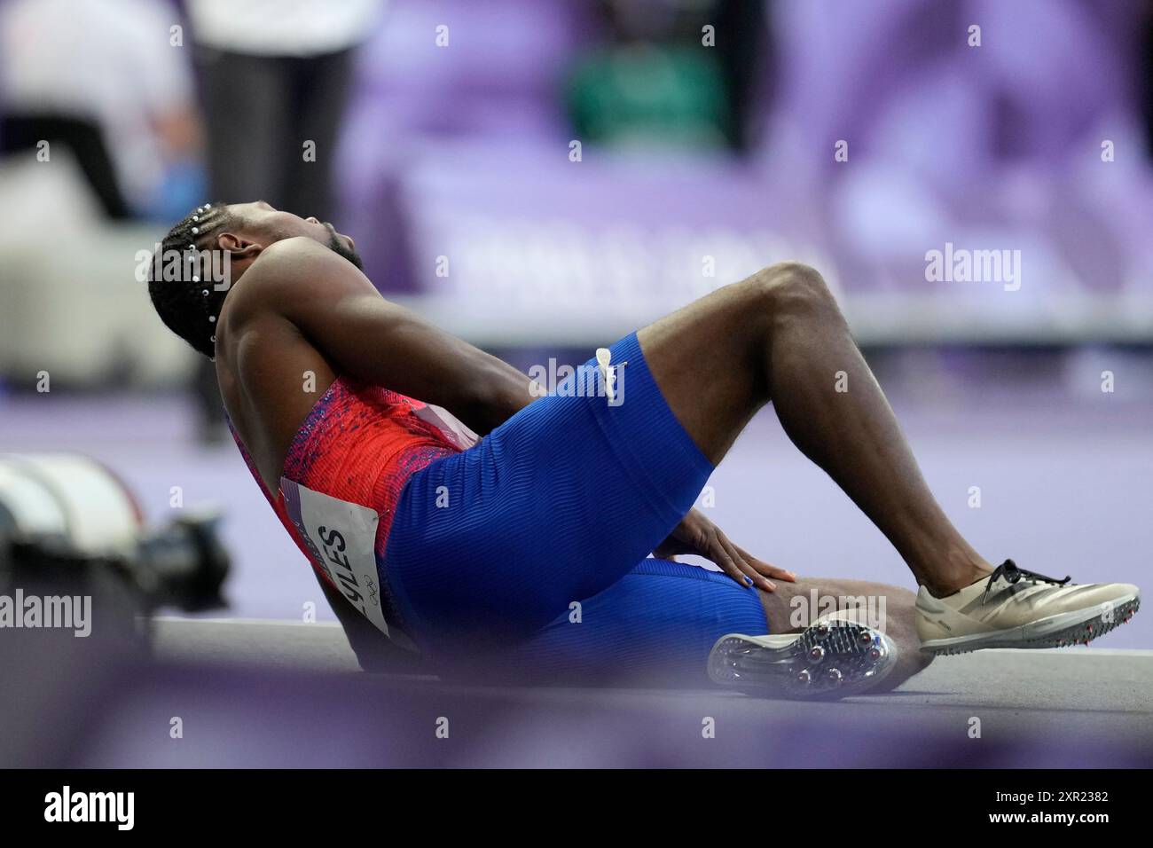 Noah Lyles, of the United States, lies down on the track after winning ...