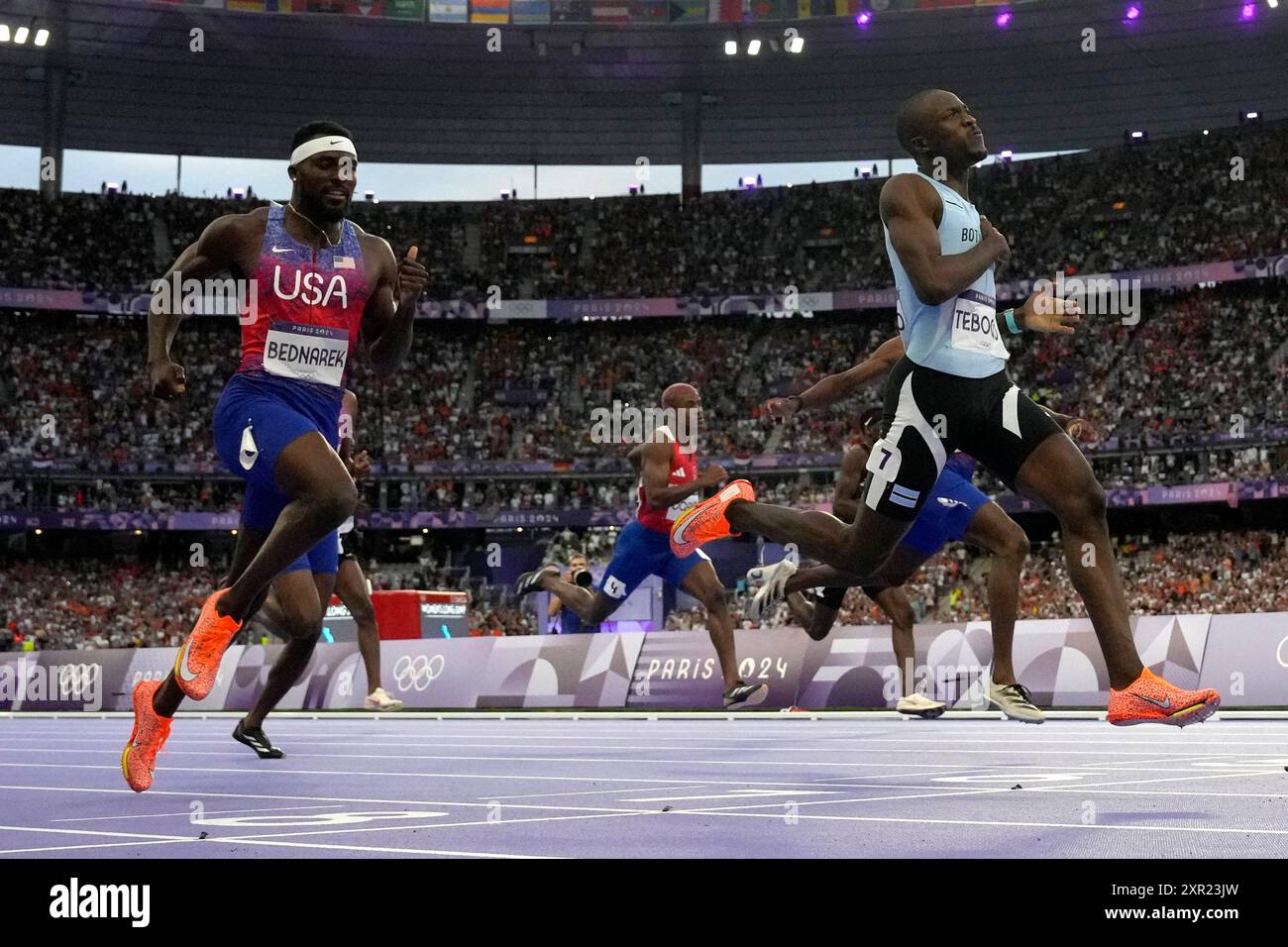 Letsile Tebogo, of Botswana, right, wins the men's 200-meters final at ...