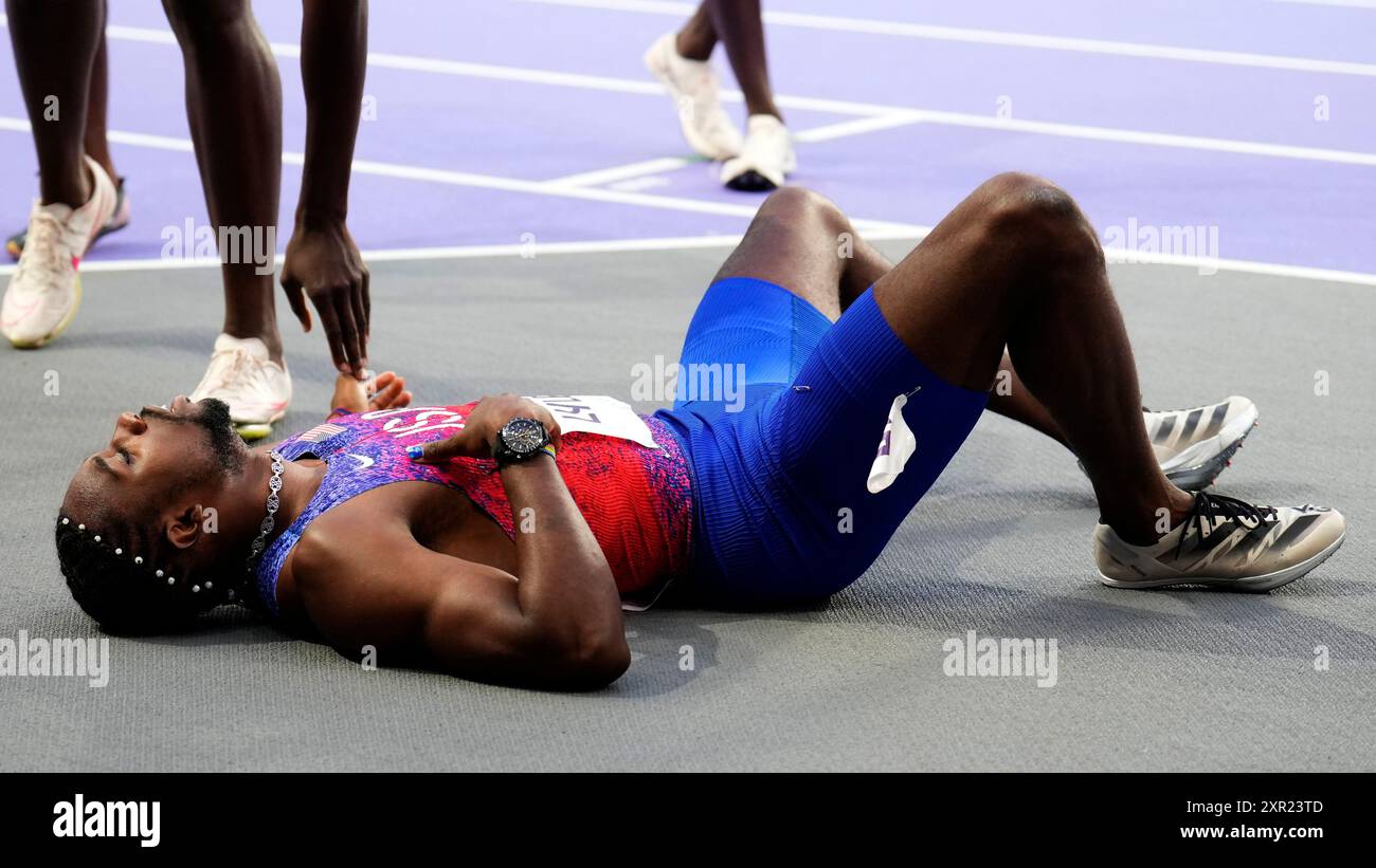 Noah Lyles, of the United States, lies on the track following the men's ...