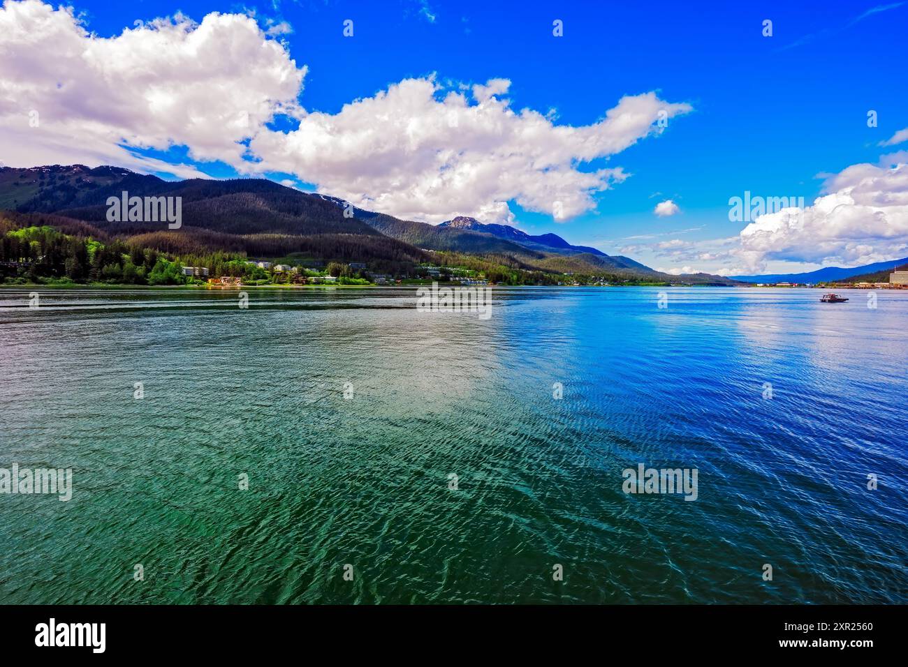Scenic fjord in Alaska under blue sky with white fluffy clouds ...
