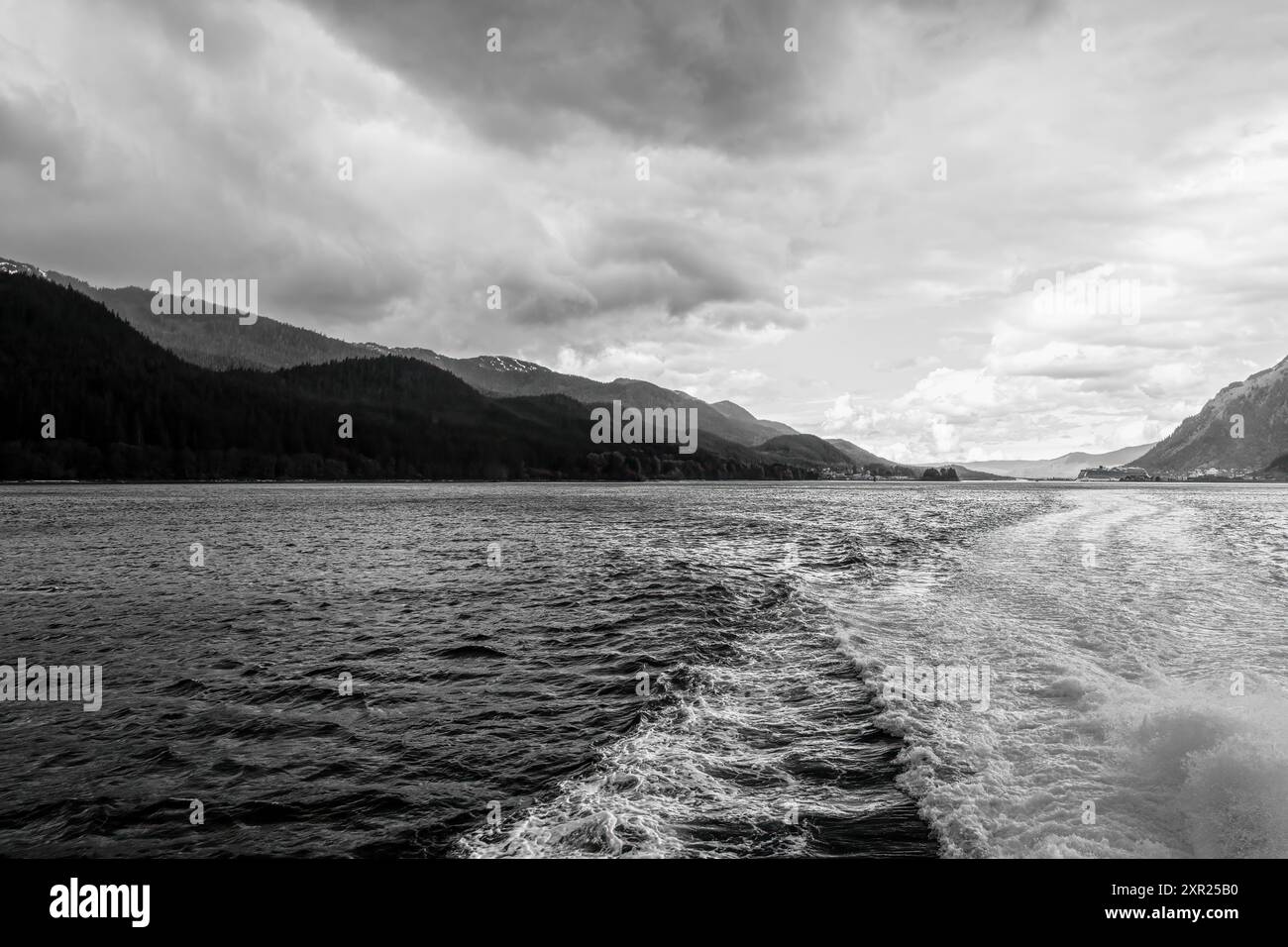 Wake from charter boat as seen from back of boat cloudy skies, and ...