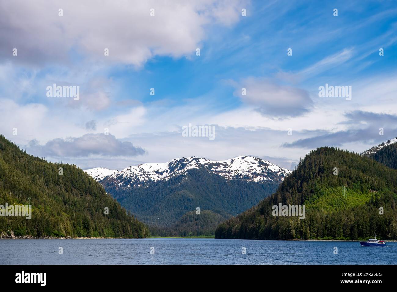 Alaska. Blue sky with white clouds, Snow capped mountain peak and ...