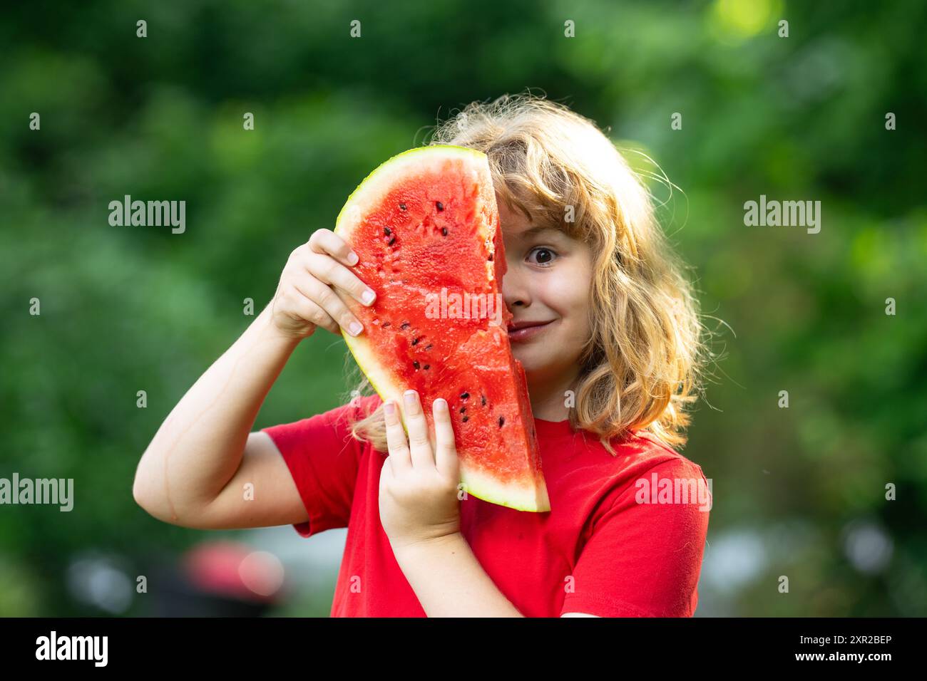 Kids face with watermelon, close up. Funny kid eating watermelon ...