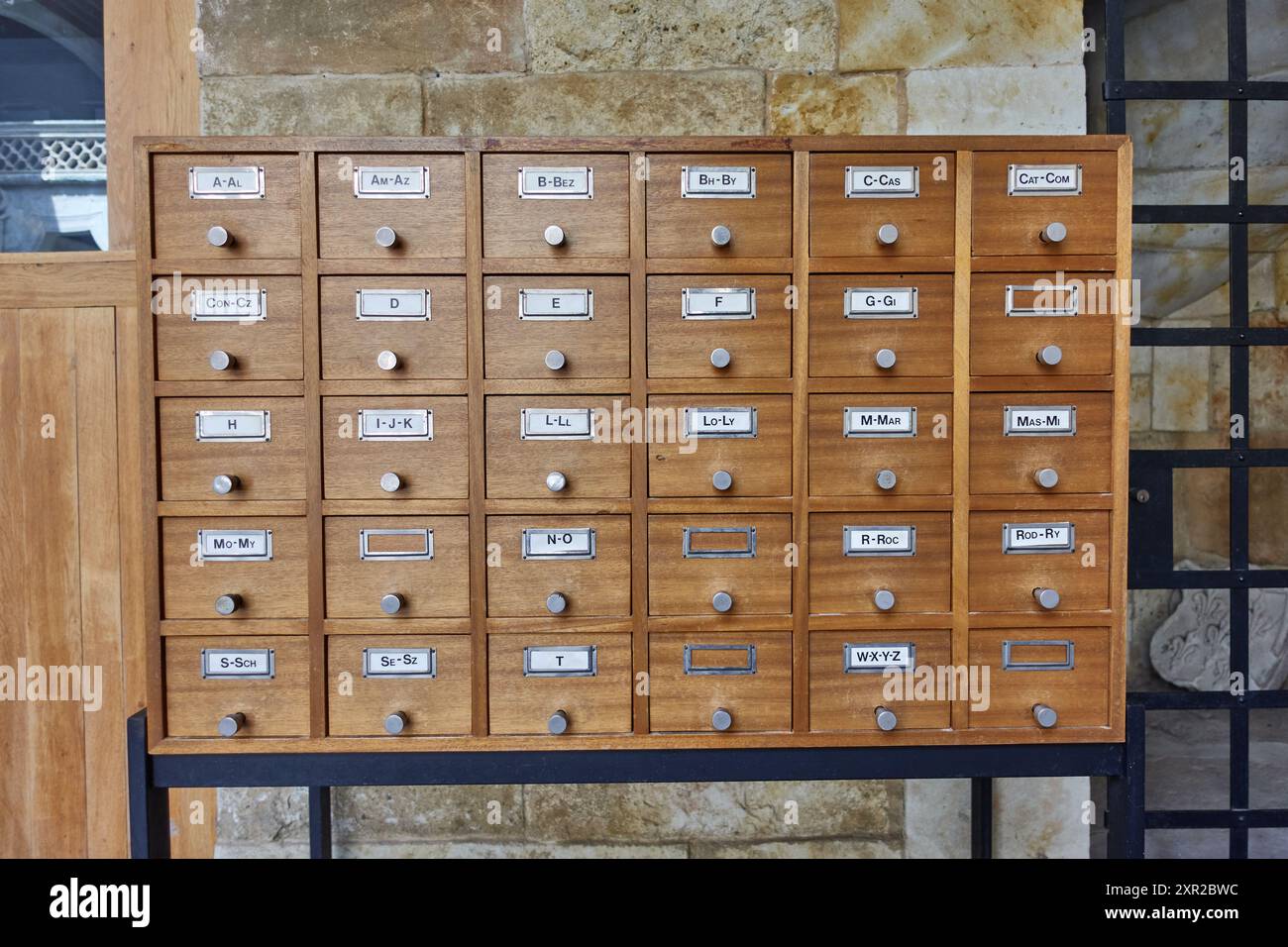 Antique wooden filing cabinet with alphabetically arranged drawers for ...