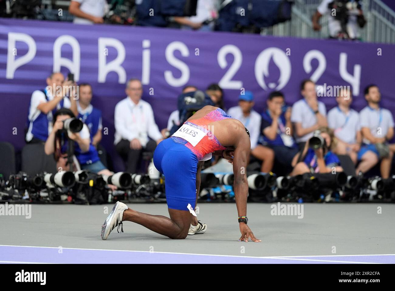 Noah Lyles, of the United States, kneels on the track after the men's ...