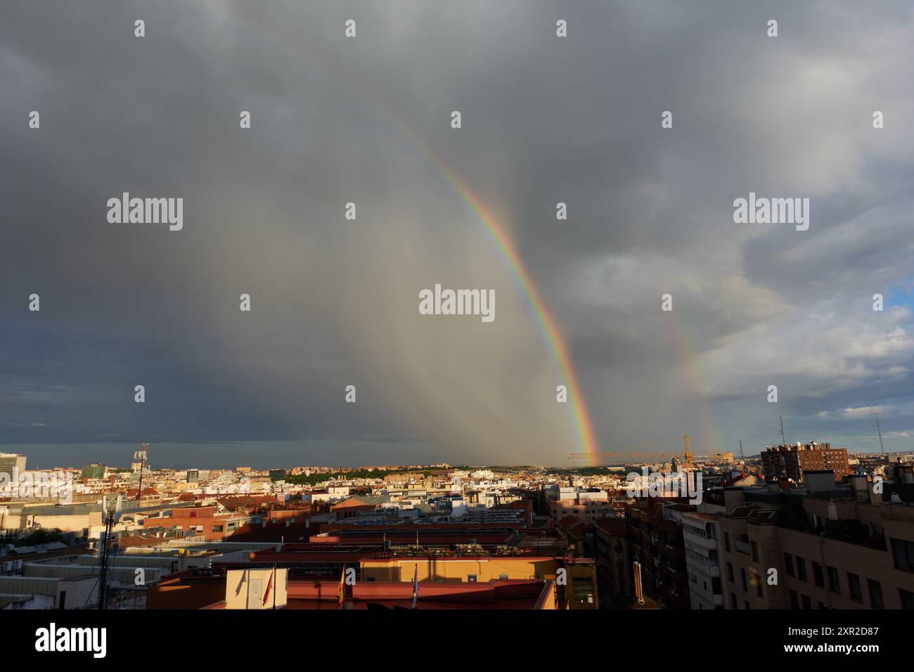 Rainbow with colorful clouds and a storm on the horizon, in the ...