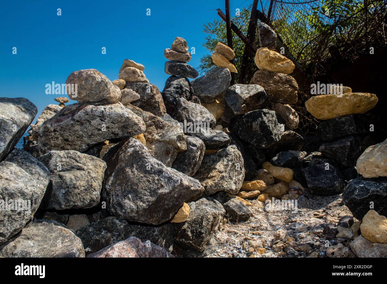 Odesa, Ukraine, August 08, 2024 Pile of stones built on Odesa beach ...